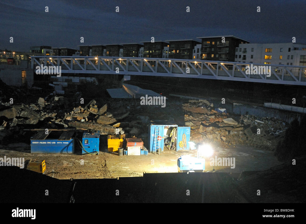 Demolition site illuminated at night showing workmen's shelter Stock ...