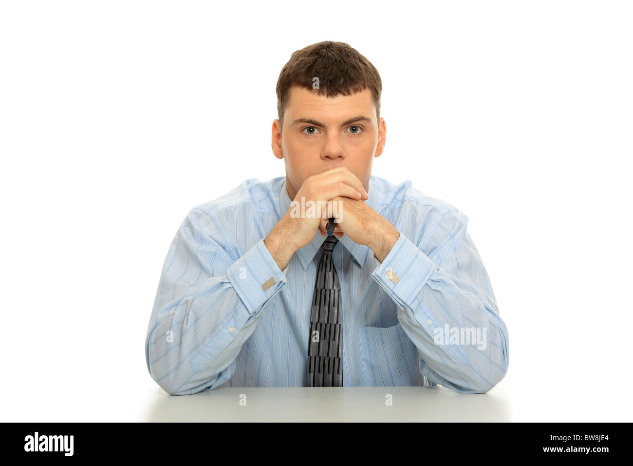 Young businessman behind the desk, isolated on white background Stock ...