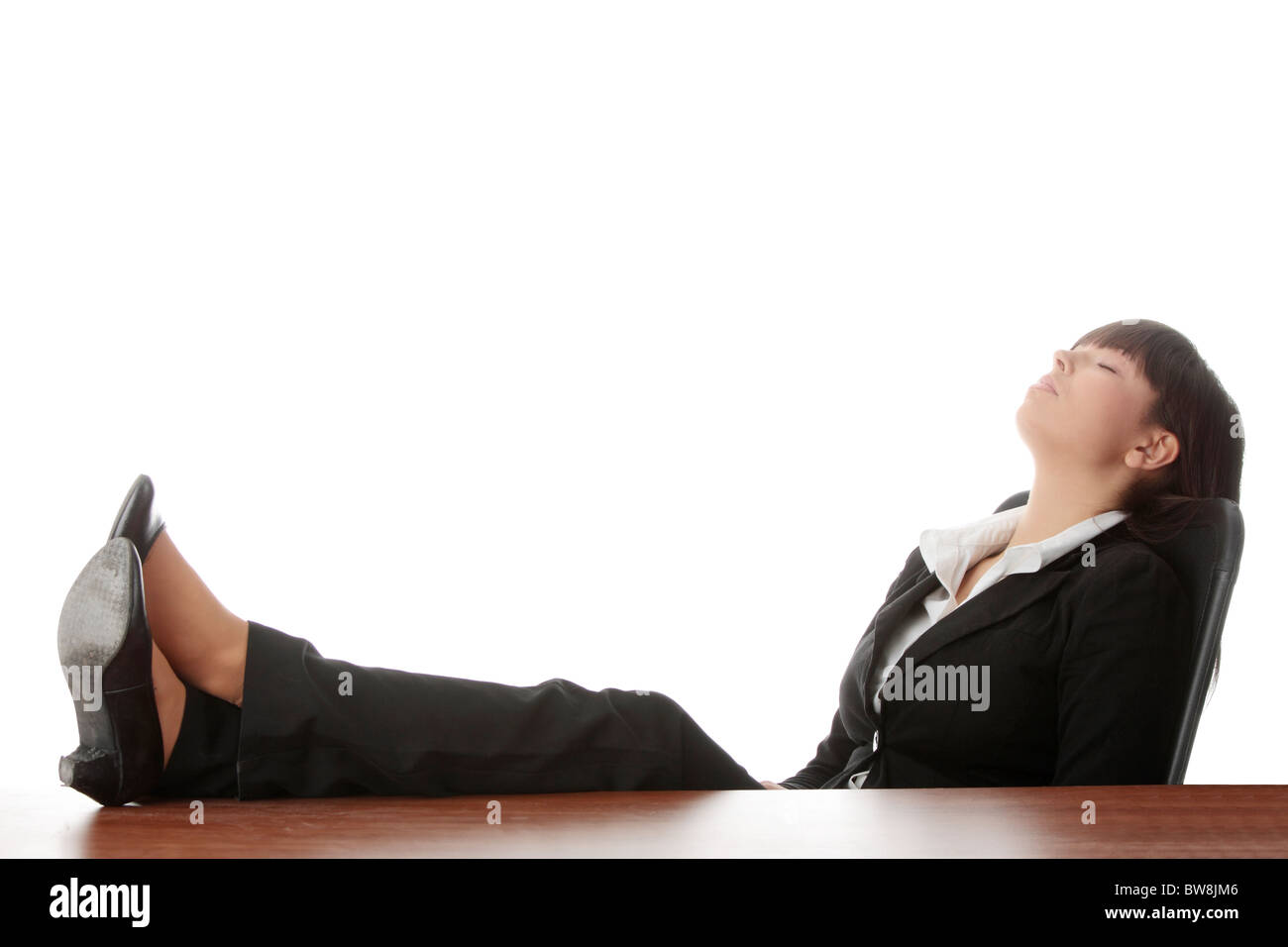 Young beautiful business lady having a rest at the working place ...
