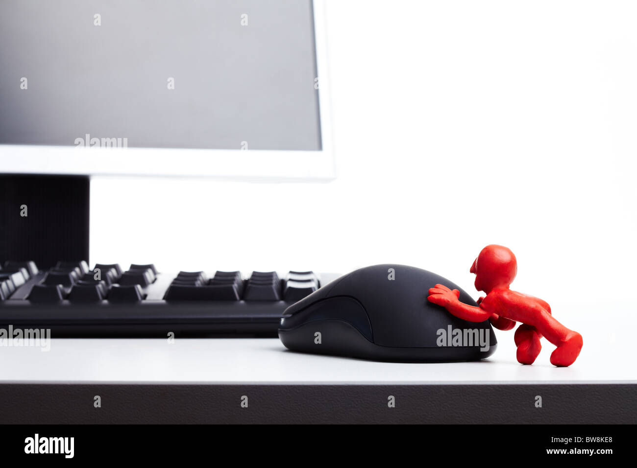 Image of plasticine man pushing computer mouse Stock Photo - Alamy