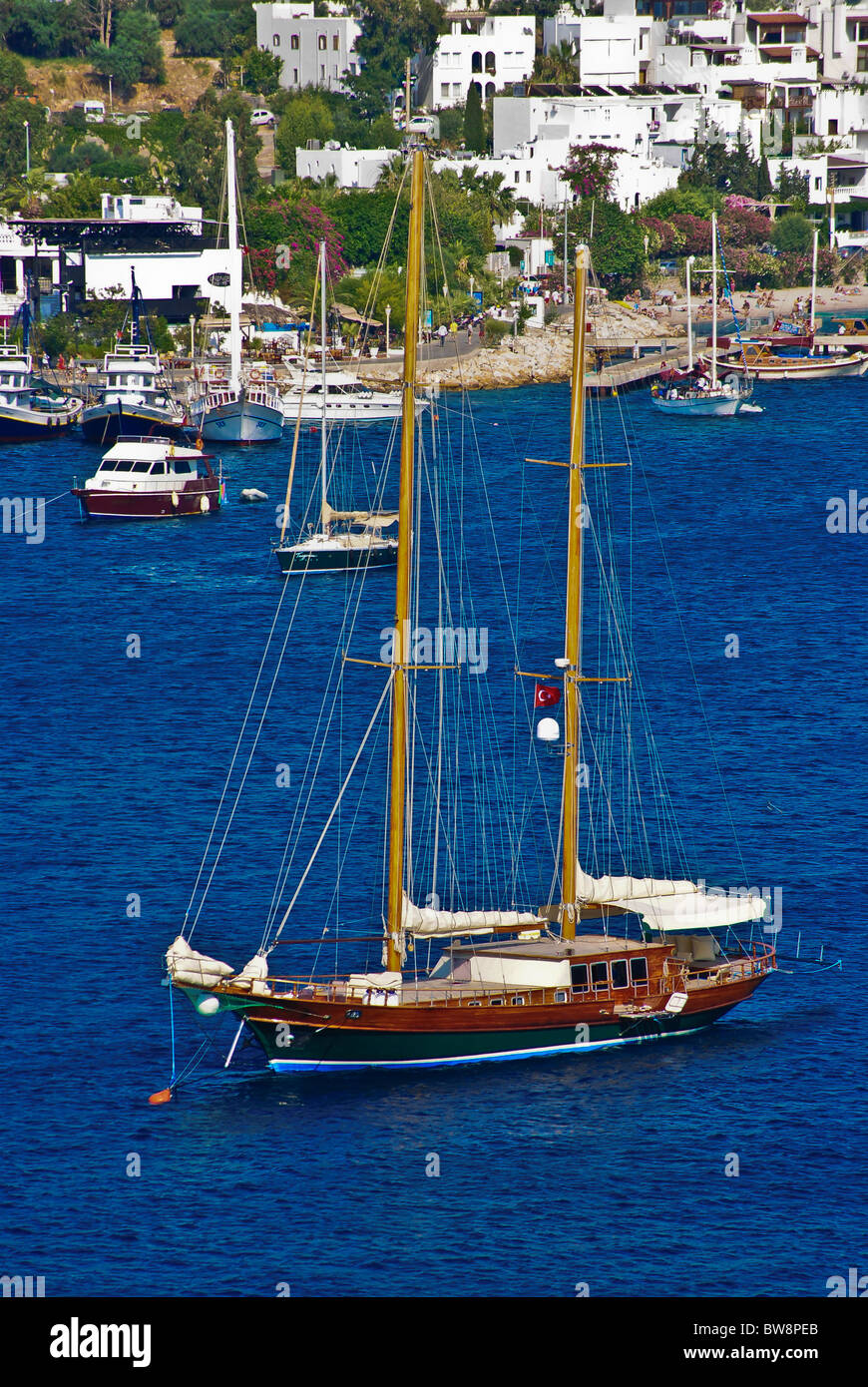 Sailing boat on blue water Stock Photo - Alamy