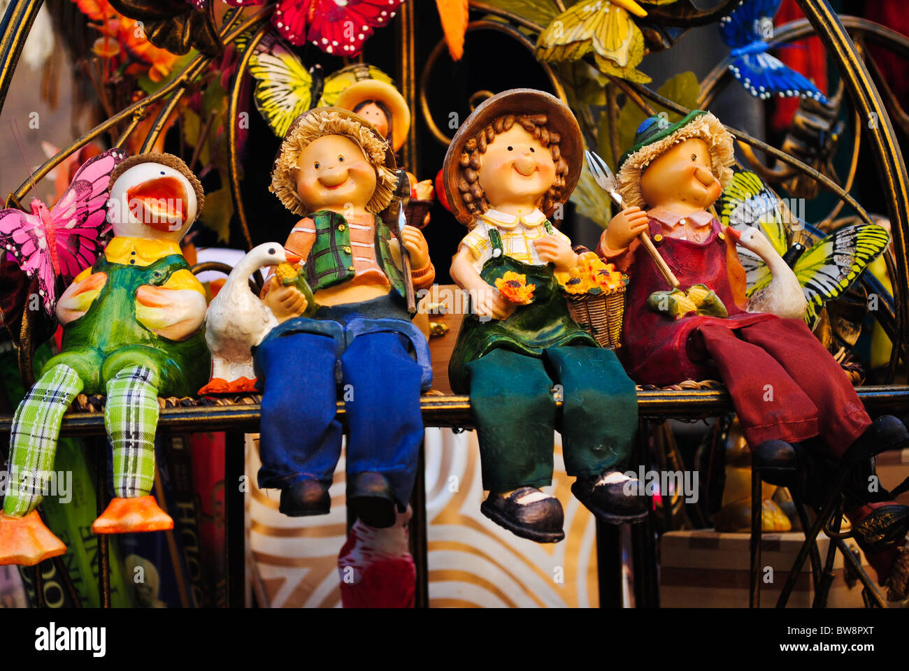 Four colorful ceramic toys sitting in line Stock Photo - Alamy