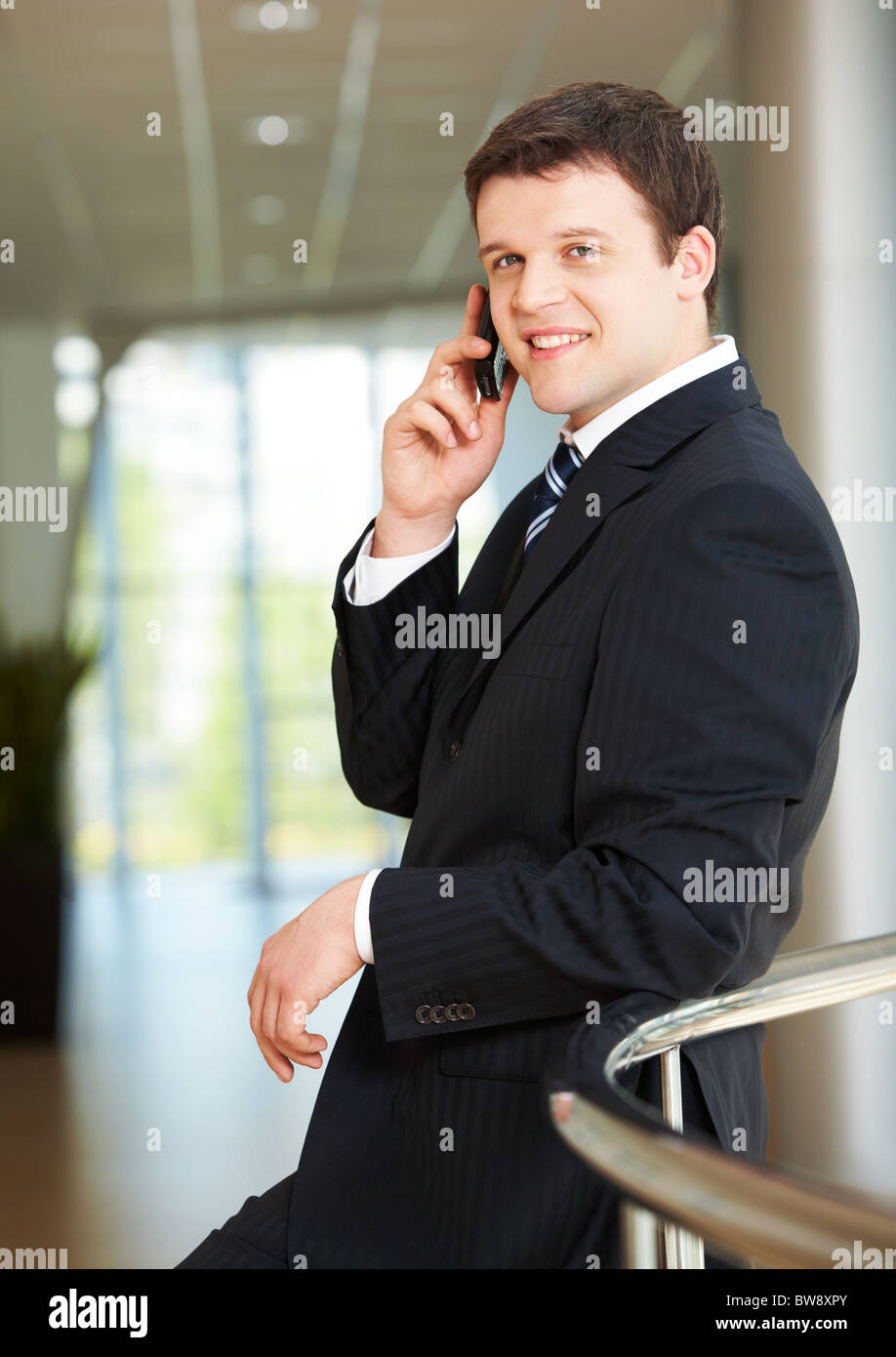 Photo of handsome employer speaking on the phone with potential ...