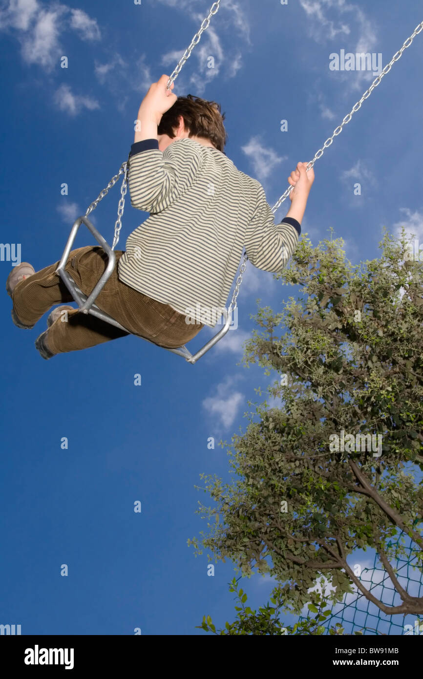 Kid playing in a swing Stock Photo - Alamy