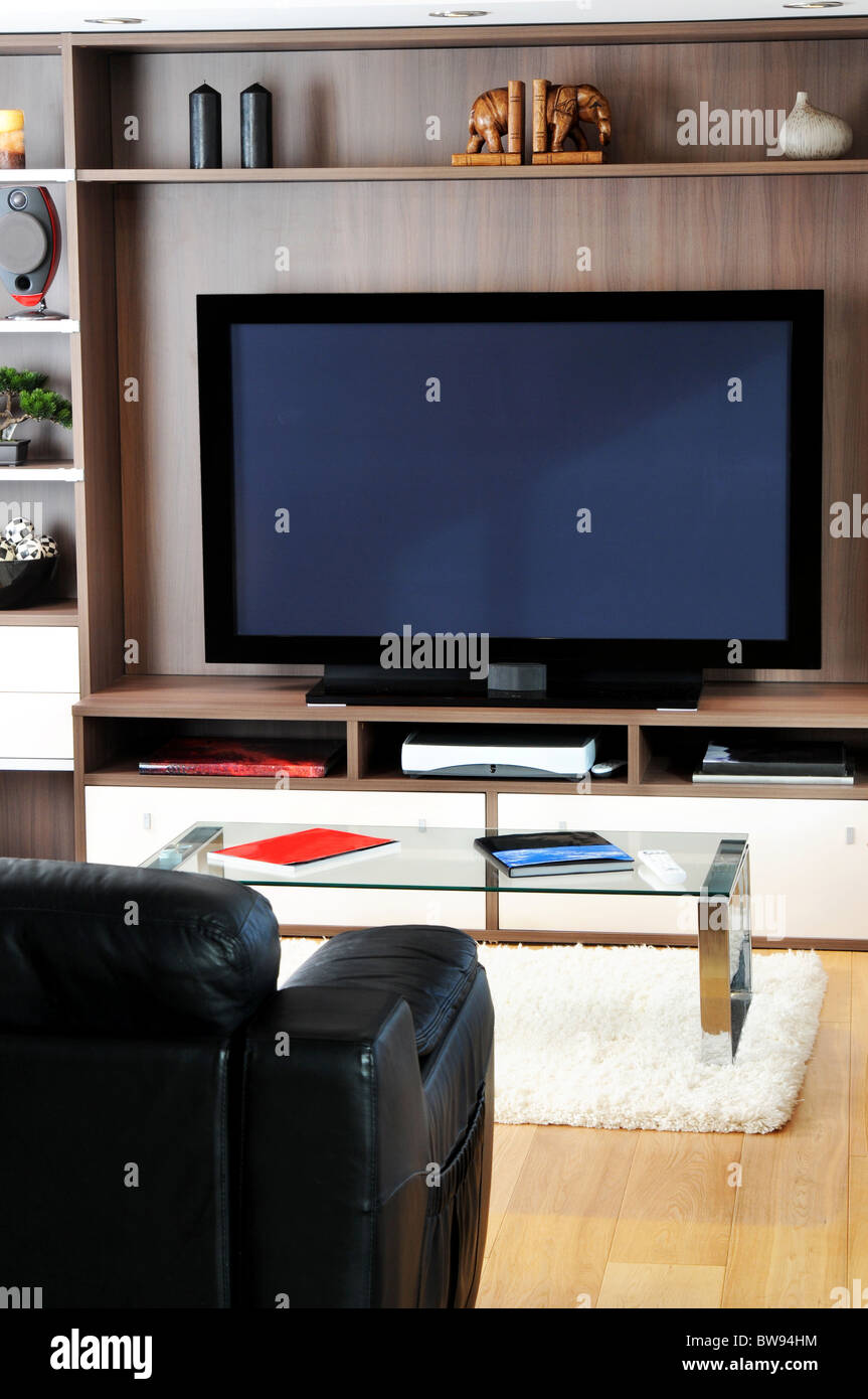 A large flat screen TV and sofa in a lounge Stock Photo - Alamy