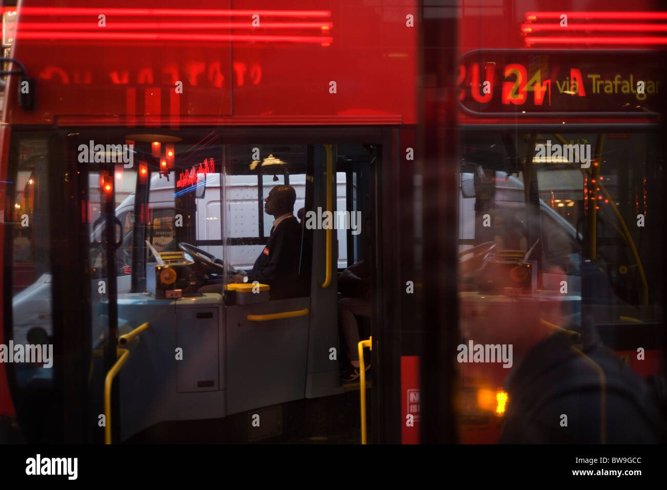 Commuters on number 24 red bus at stop in Charing Cross Road in central ...
