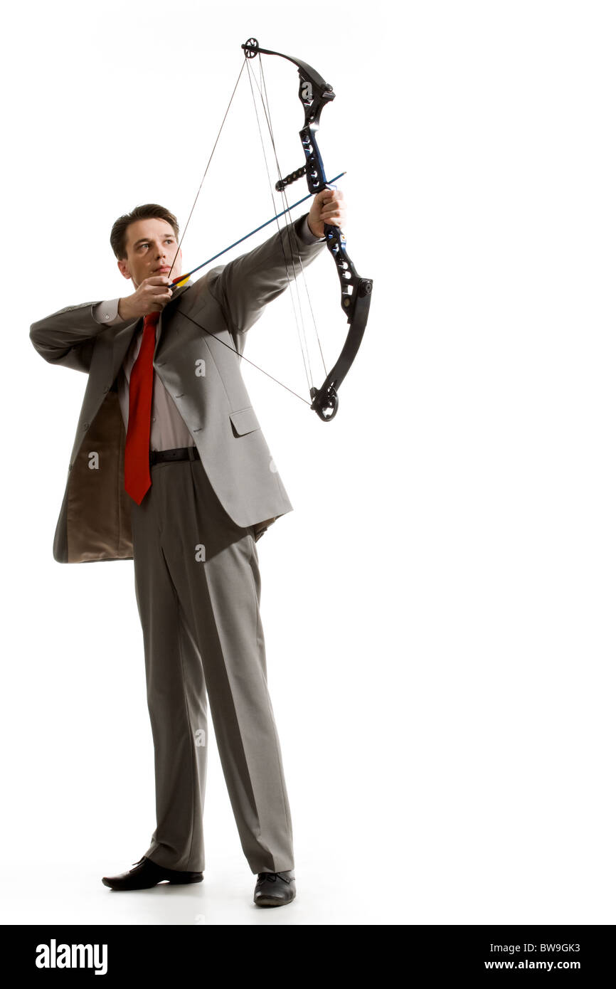 Portrait of courageous businessman holding crossbow and aiming at ...