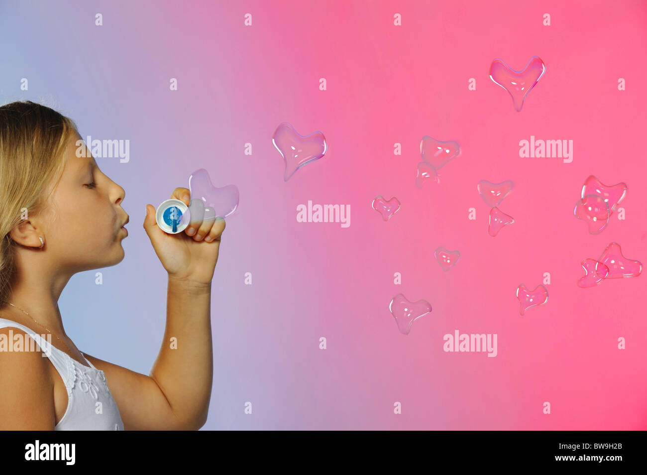 The pretty girl with bubbles heart. A blue background Stock Photo - Alamy