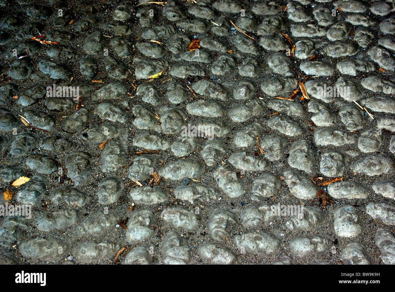 Creepy small cast concrete faces made to look like cobblestones on ...