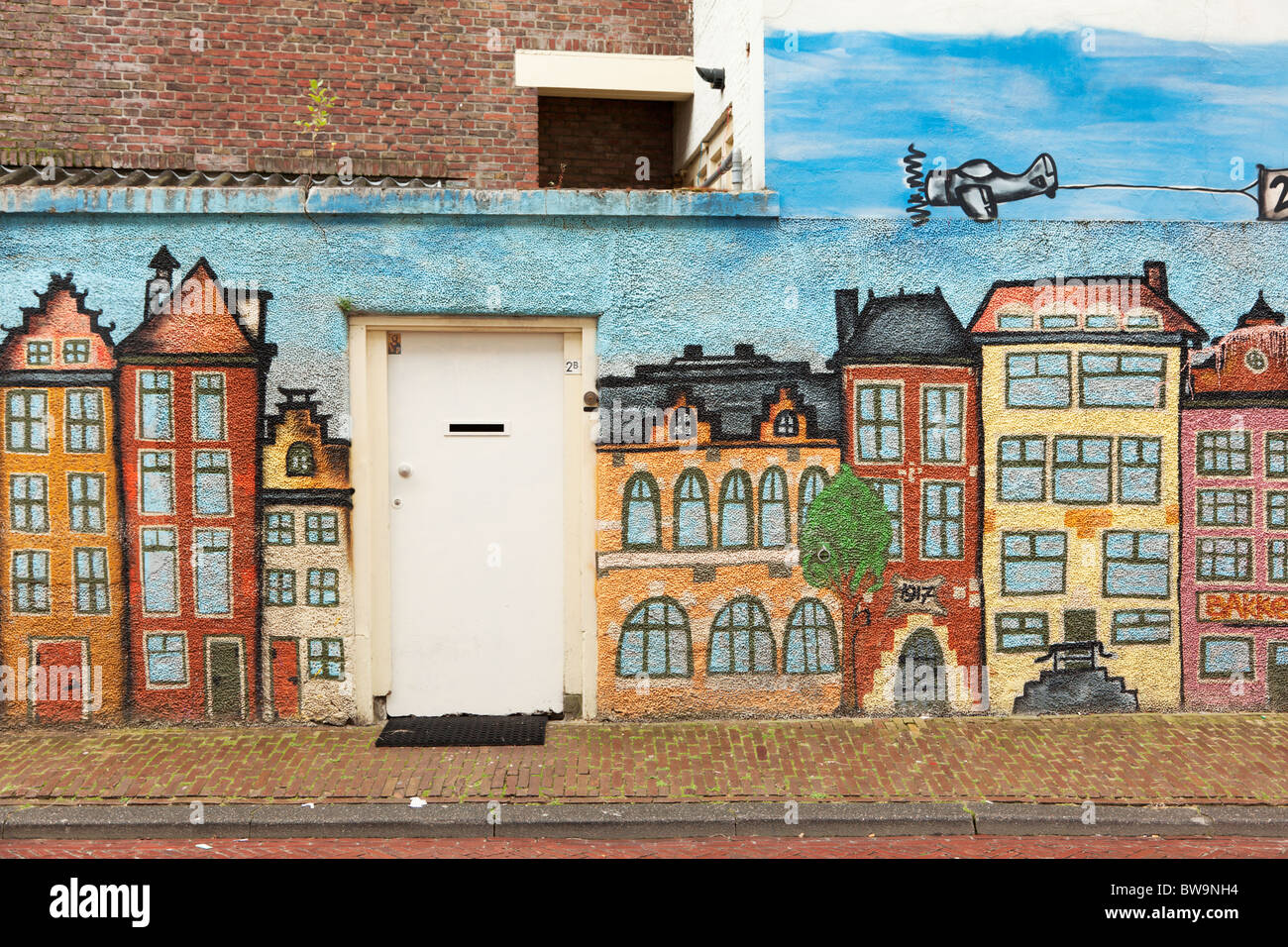Wall with graffiti street art of Dutch houses Stock Photo - Alamy