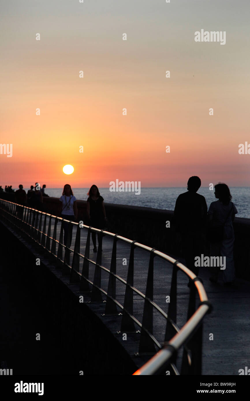 People stroll the promenade in San Sebastian, Spain at sunset Stock ...