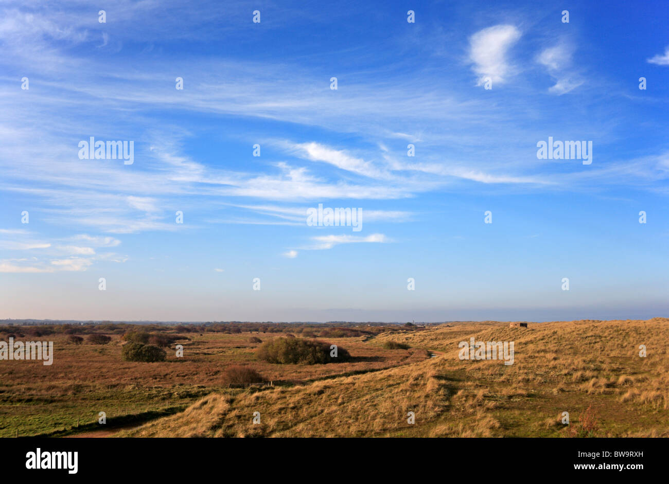 A landscape of grazing marsh from sand dunes with cirrus clouds at ...