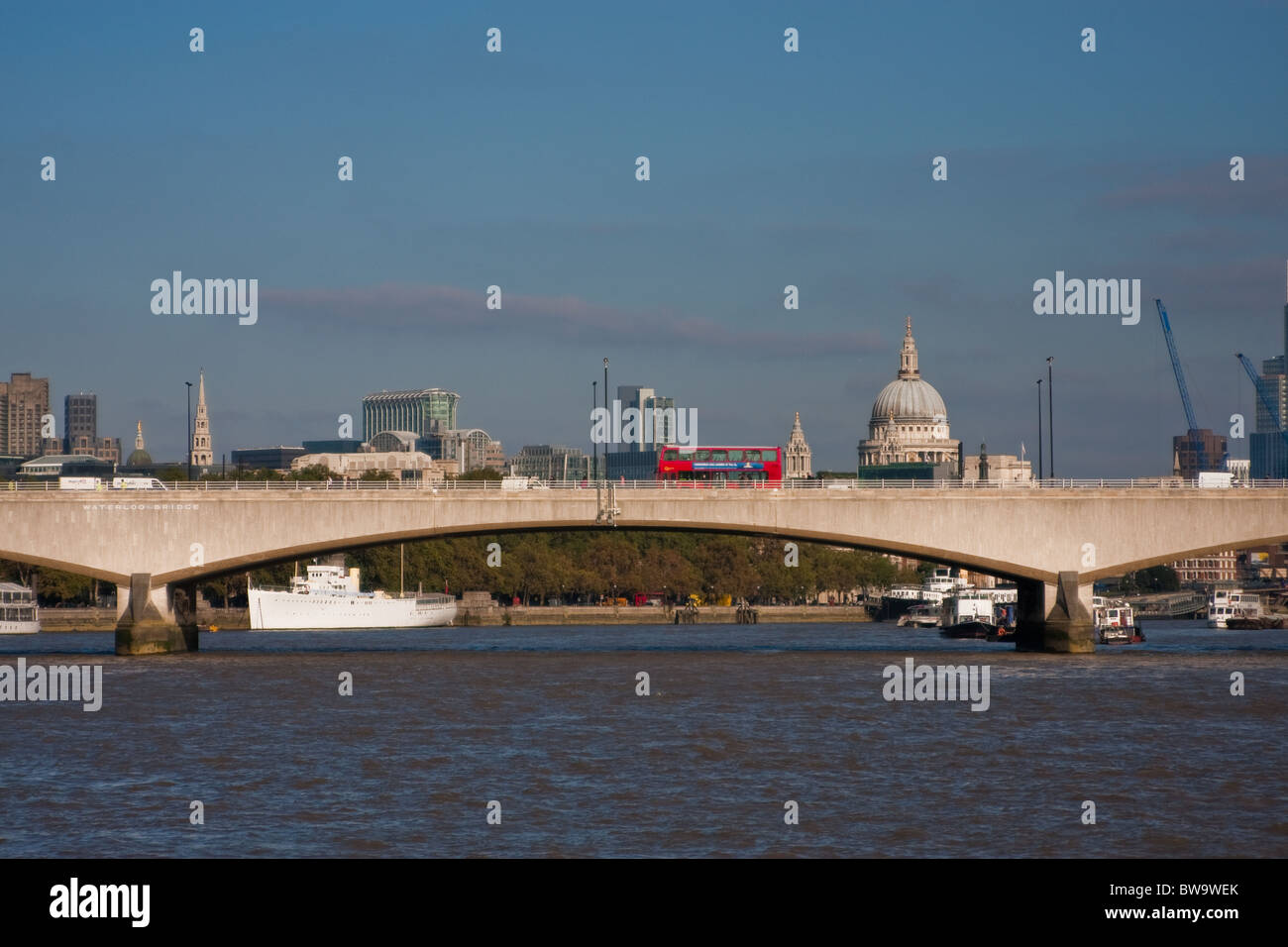 Waterloo Bridge, crossing the Thames River, boats and the London ...