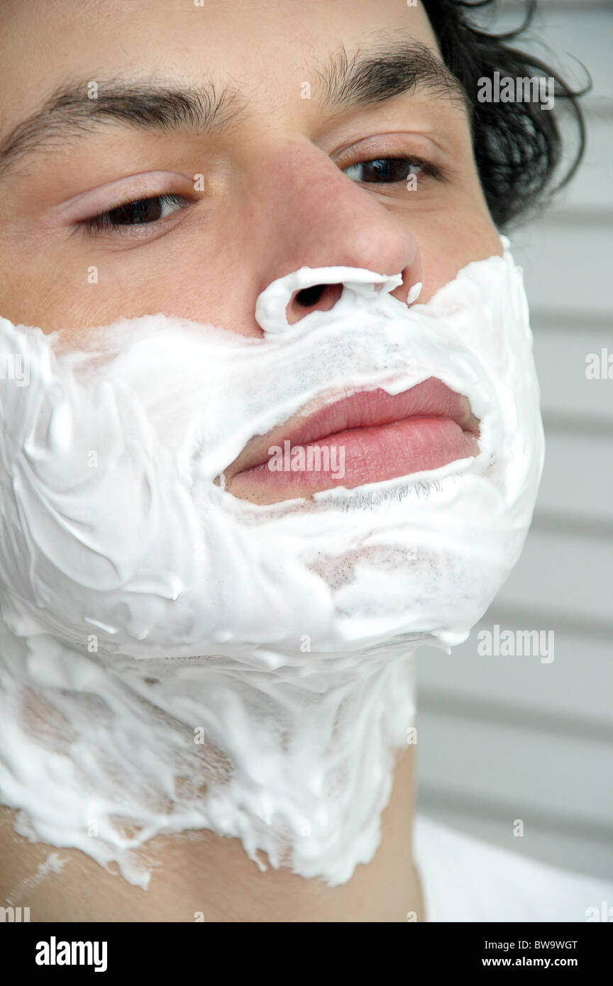 Young man with shaving foam on his face Stock Photo - Alamy