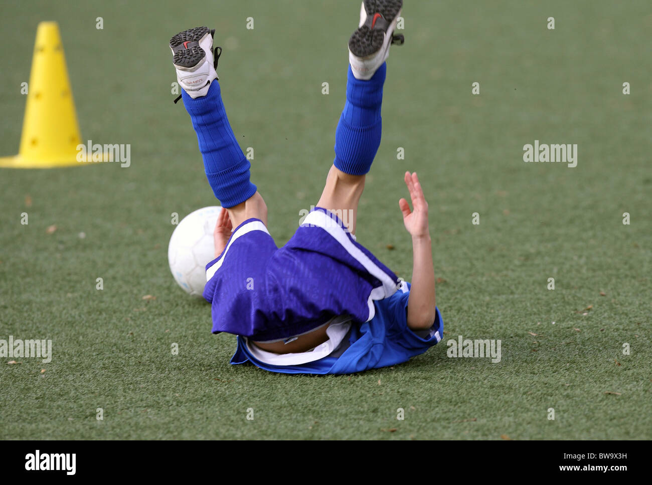 A boy fouled during a football match Stock Photo - Alamy