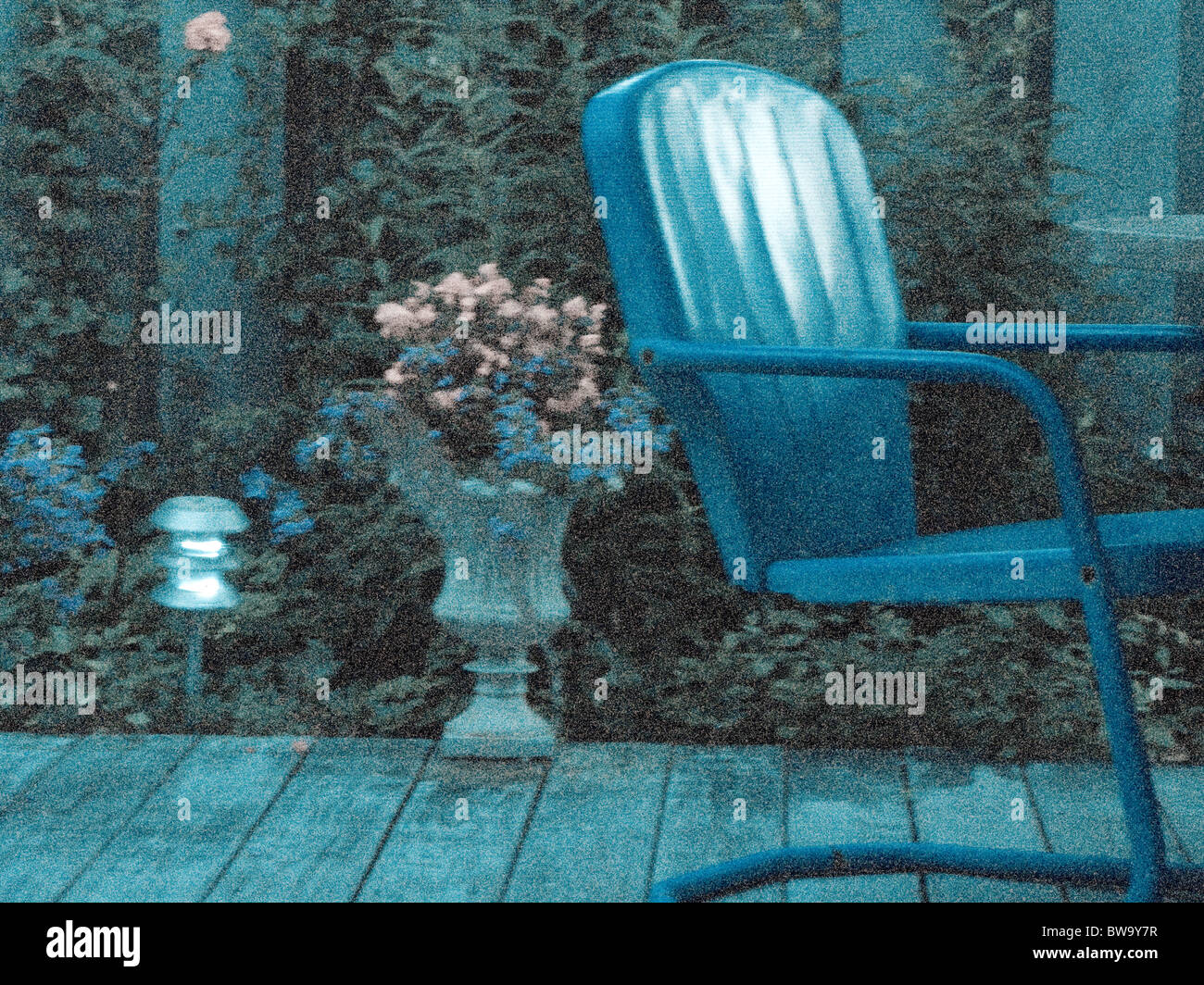 grainy shot of old blue chair with flowers on wood deck Stock Photo - Alamy