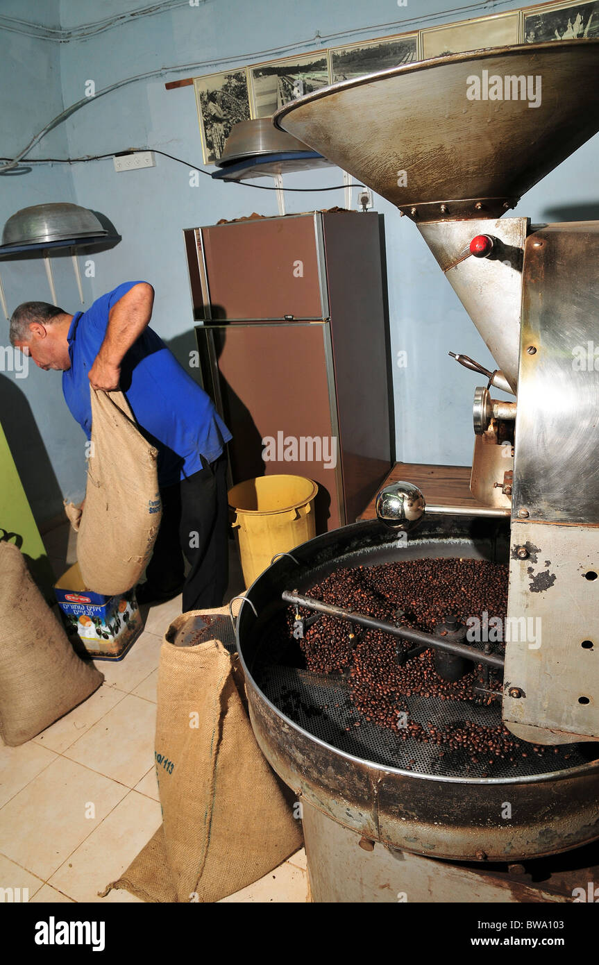 Israel, Nazareth, small coffee roasting shop Beans being roasted in a ...