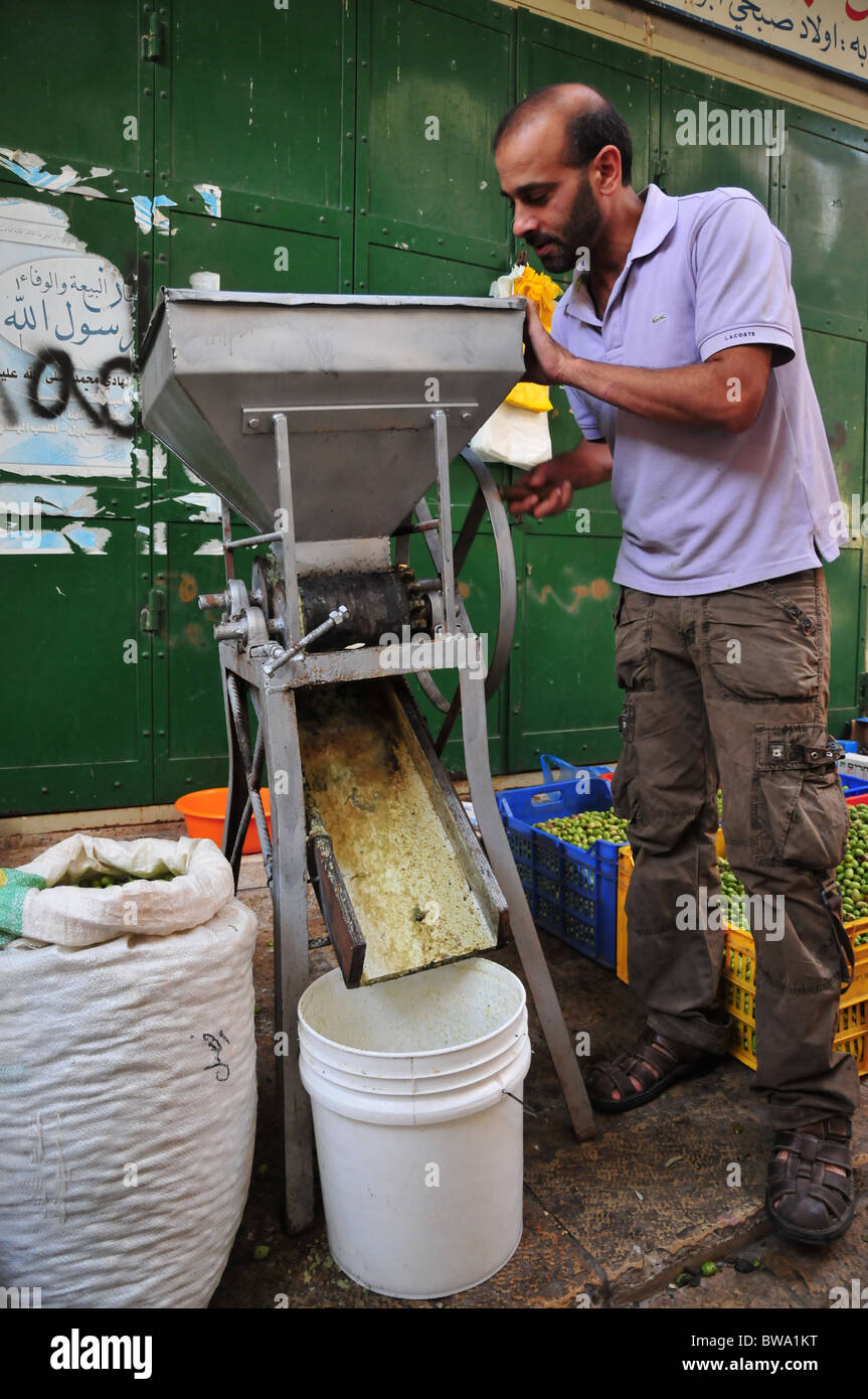 Manual olive press to extract olive oil Stock Photo - Alamy