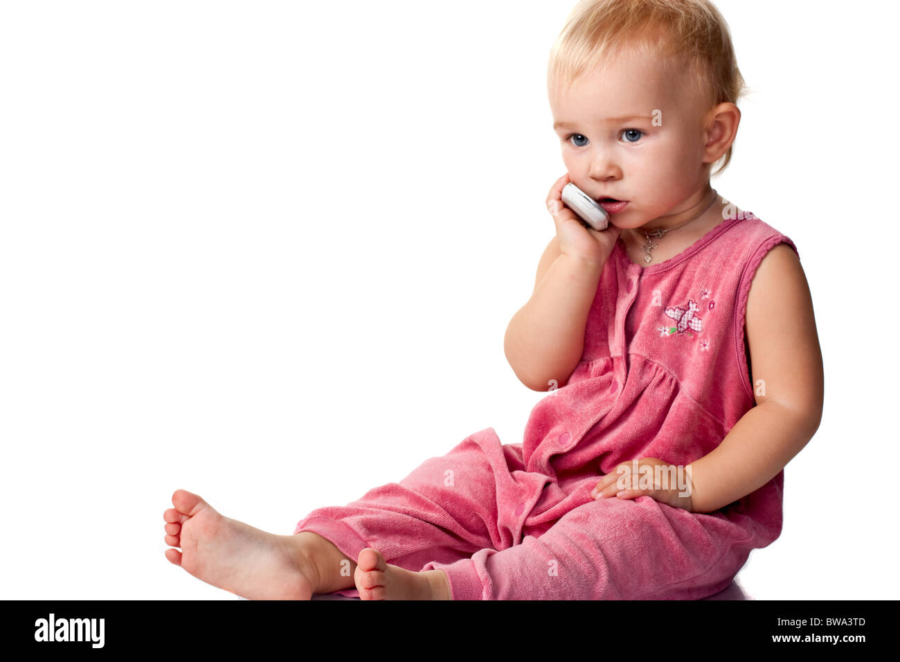 Baby talking on the mobile phone isolated Stock Photo - Alamy
