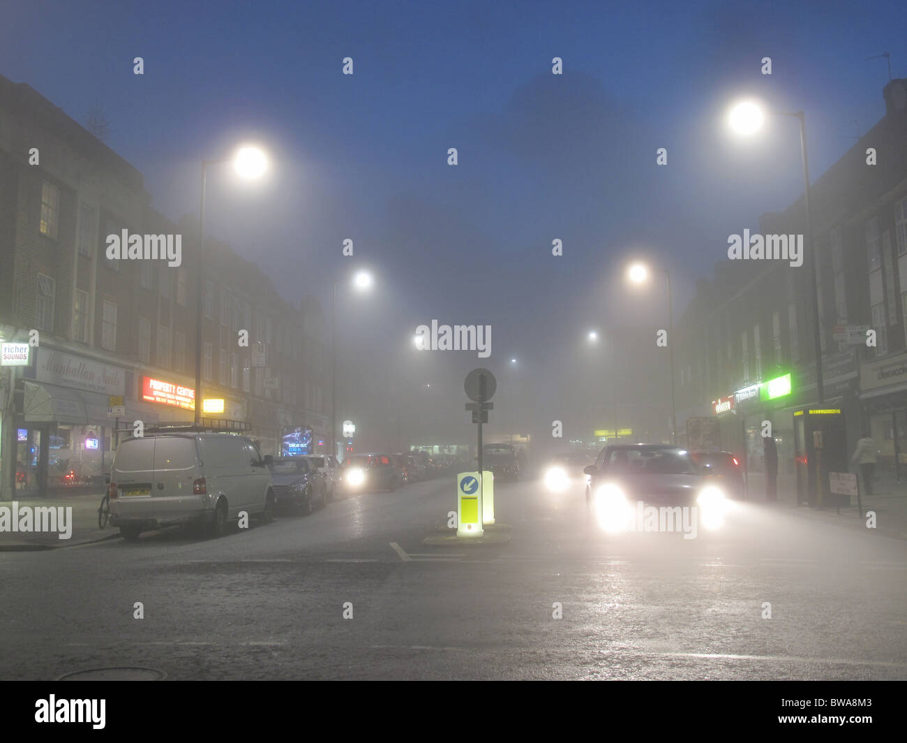 London fog night dark foggy day street lights Stock Photo - Alamy