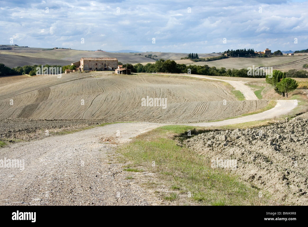 Winding dirt road across the Sienese crete landscape of Tuscany Italy ...