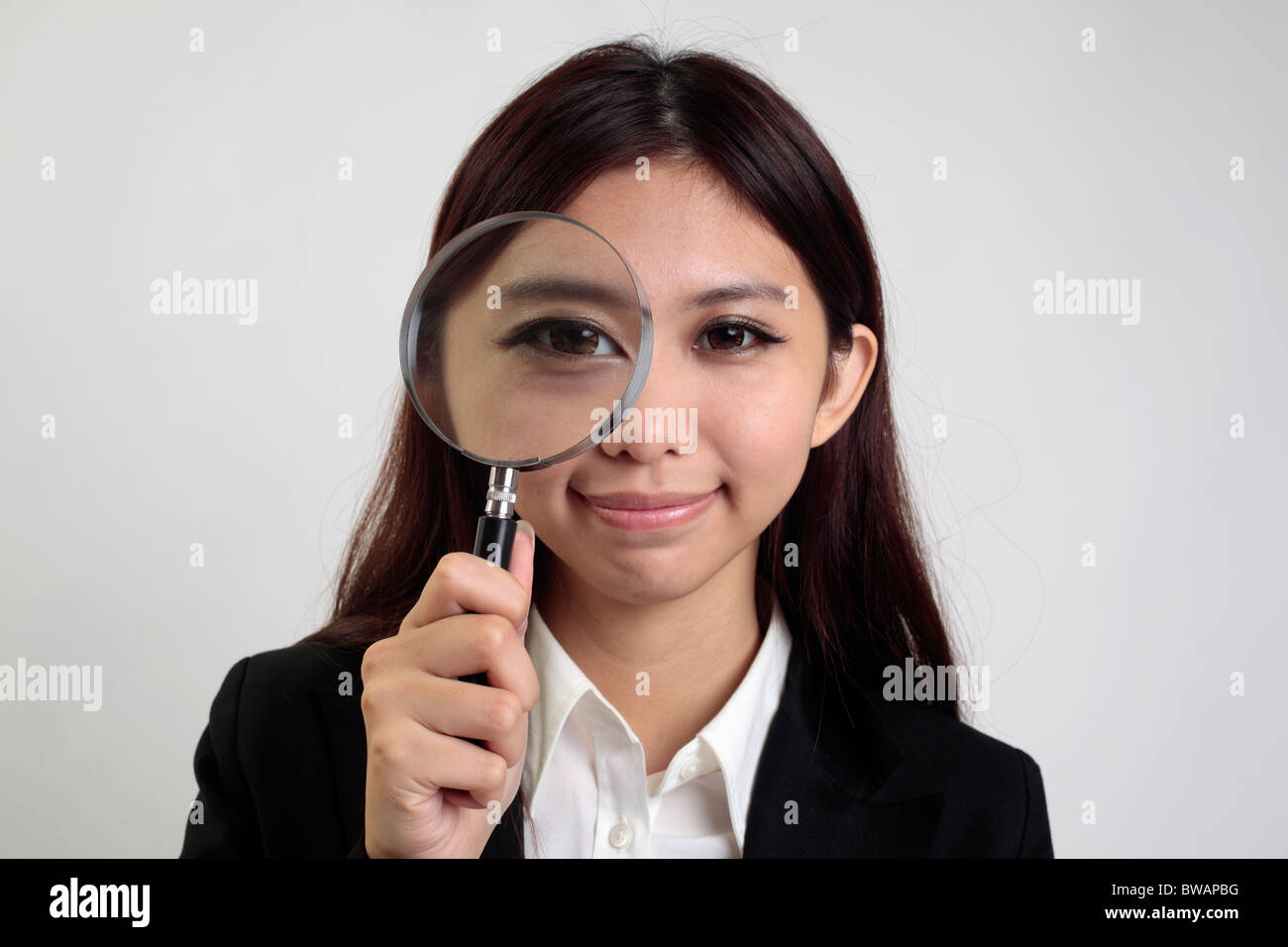 Office lady plays magnifier Stock Photo - Alamy