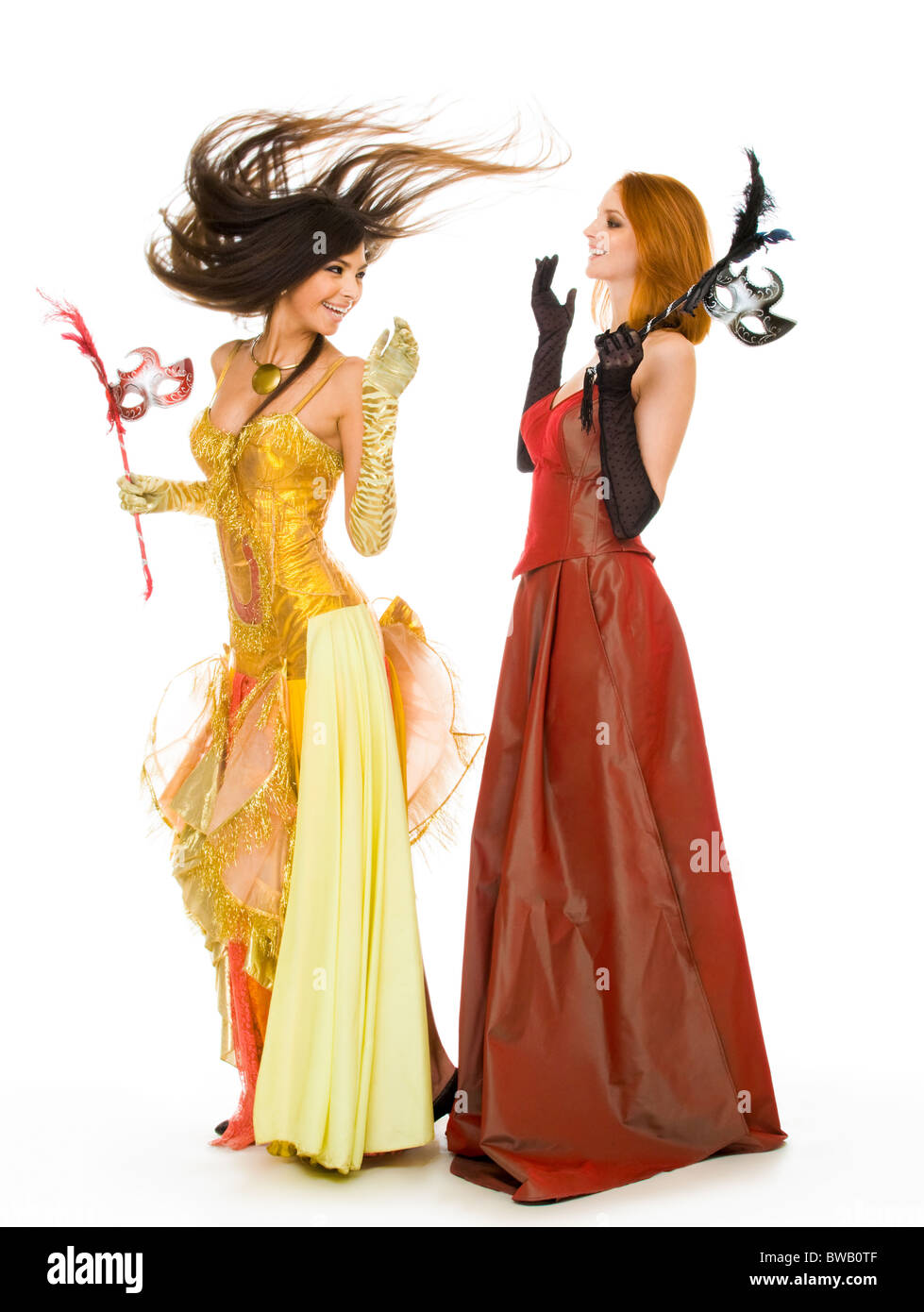 Photo of joyful actresses in fashionable dresses having fun over white ...