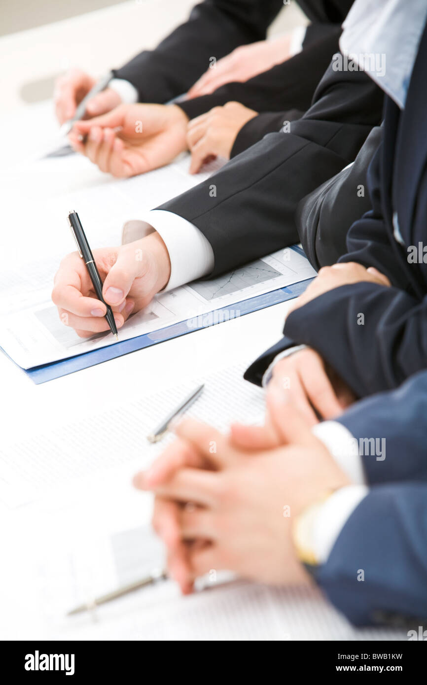 Image of row of people hands over papers during briefing Stock Photo ...
