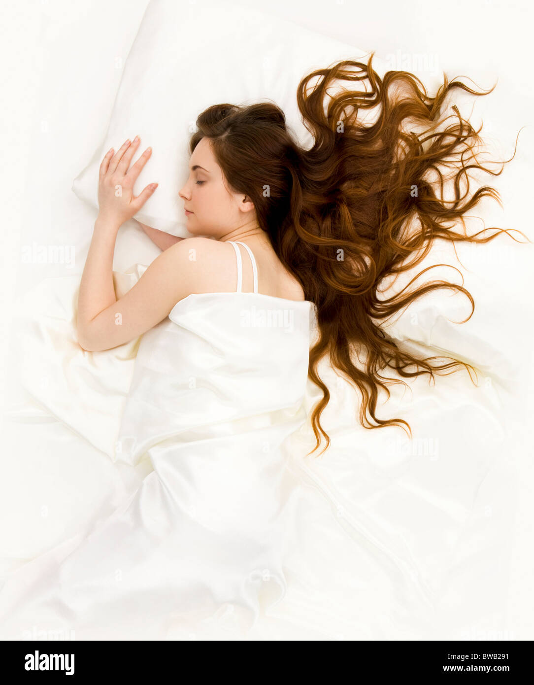 Woman sleeping in bed back view Cut Out Stock Images & Pictures - Alamy