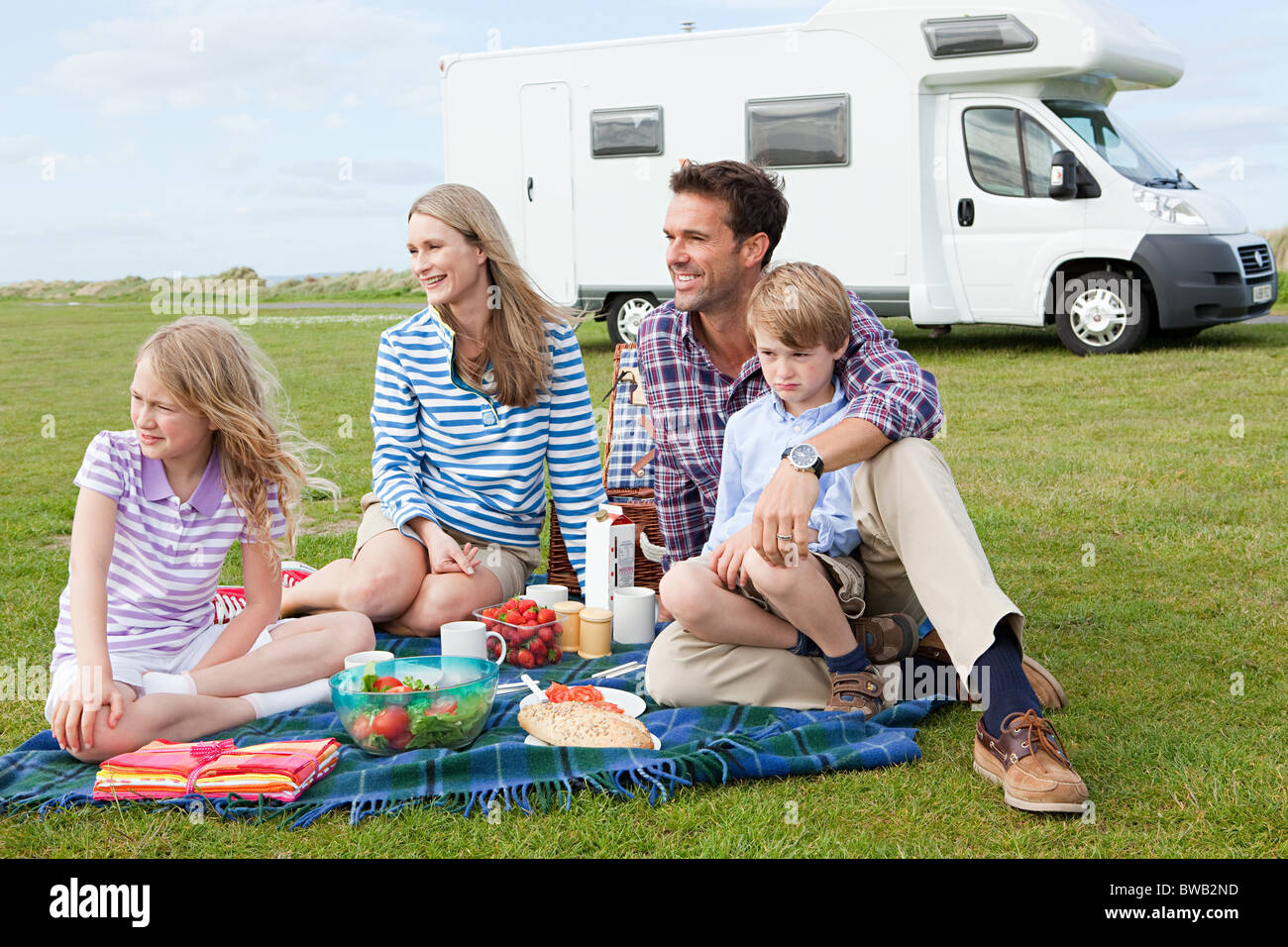Family having picnic by caravan Stock Photo - Alamy