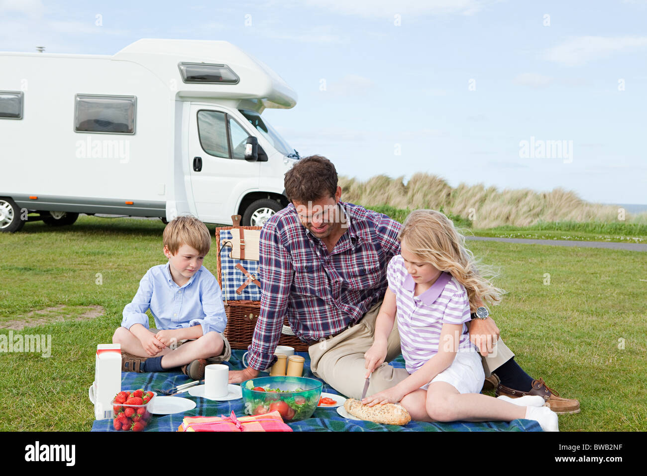 Father and children having picnic by caravan Stock Photo - Alamy