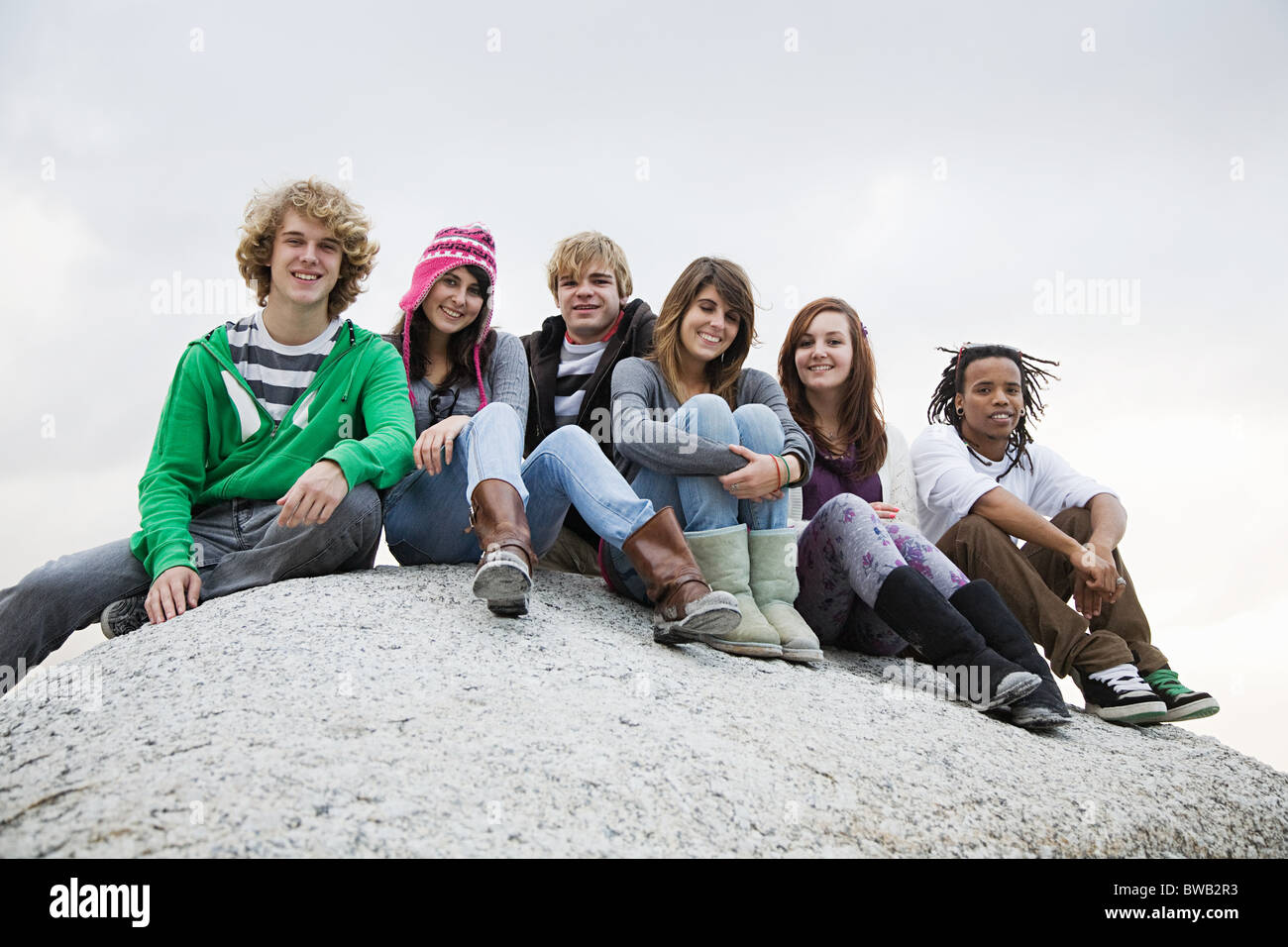 Group people sitting rocks hi-res stock photography and images - Alamy