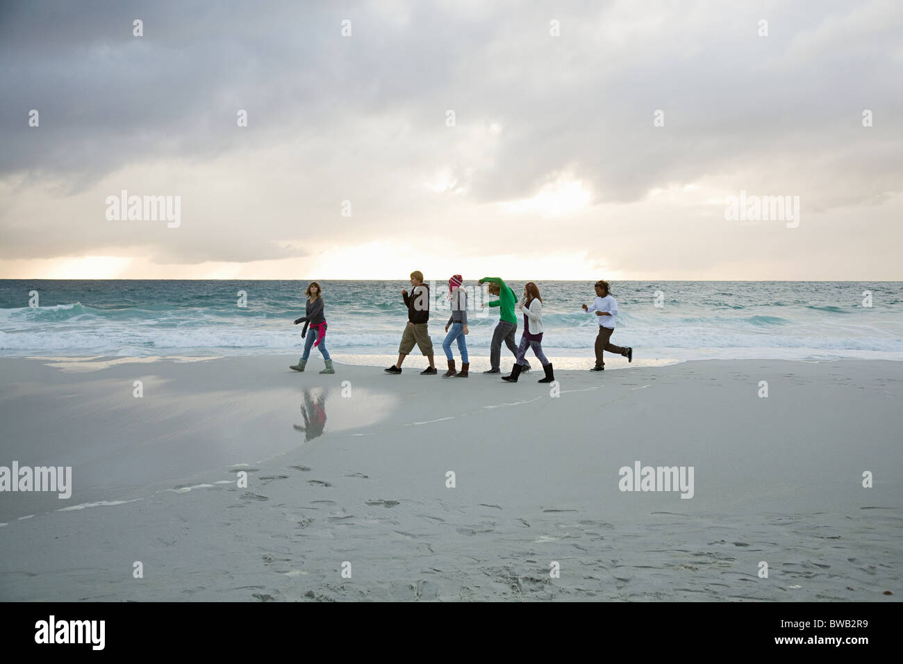 People walking on beach Stock Photo - Alamy