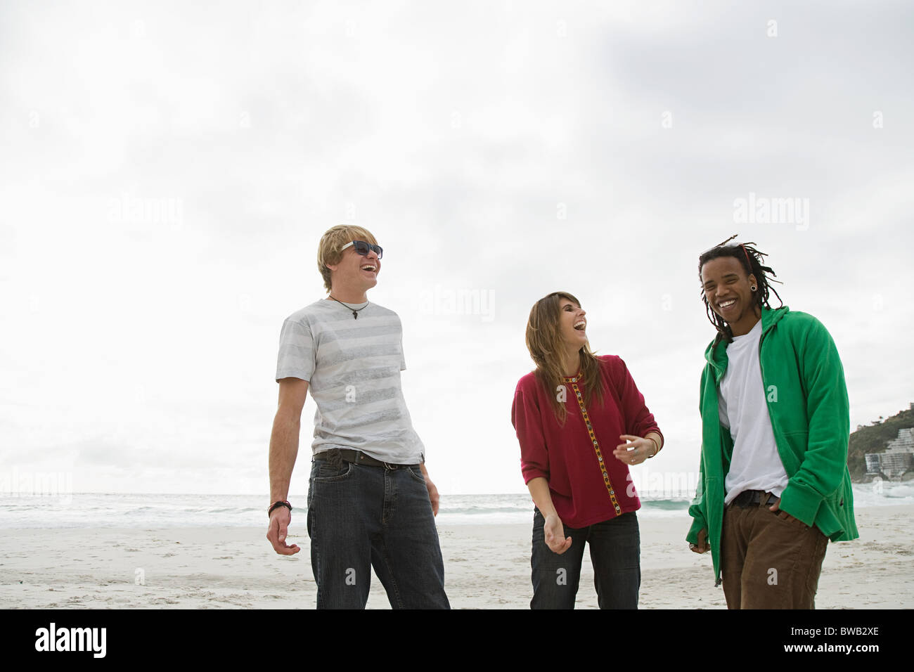 Three young people on beach Stock Photo - Alamy