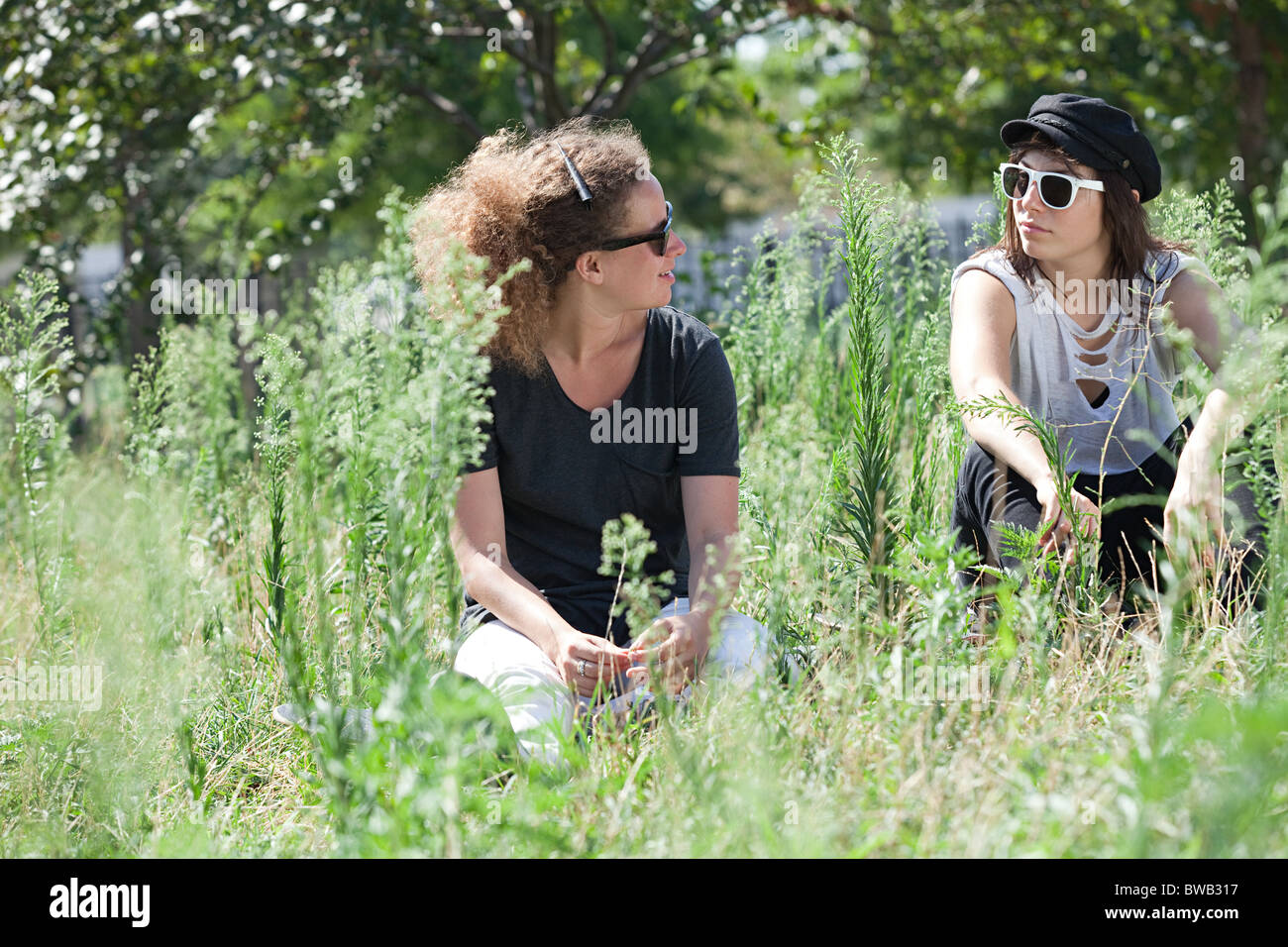 Young women hanging out Stock Photo - Alamy