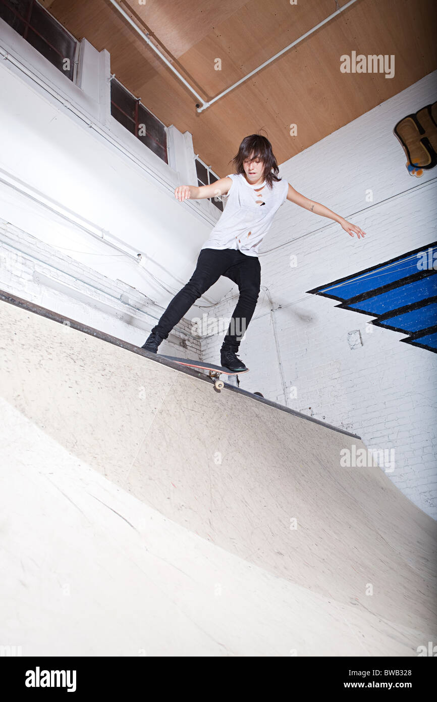Skateboarder on ramp at skate park Stock Photo - Alamy