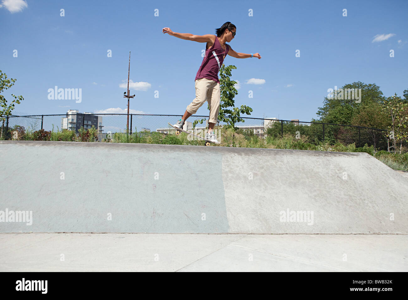 Skateboarder on ramp at skate park Stock Photo - Alamy