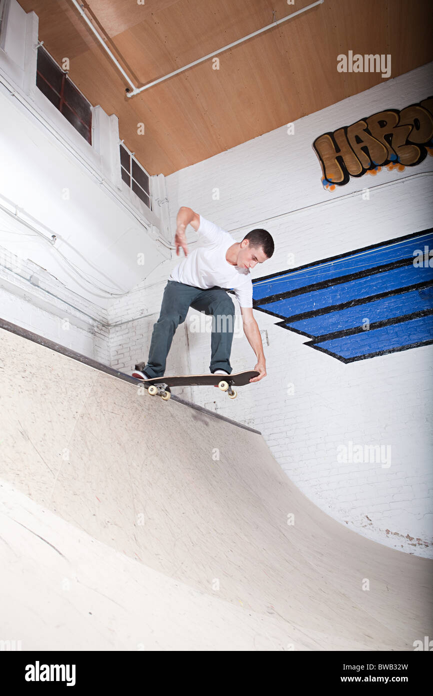 Skateboarder on ramp at skate park Stock Photo - Alamy