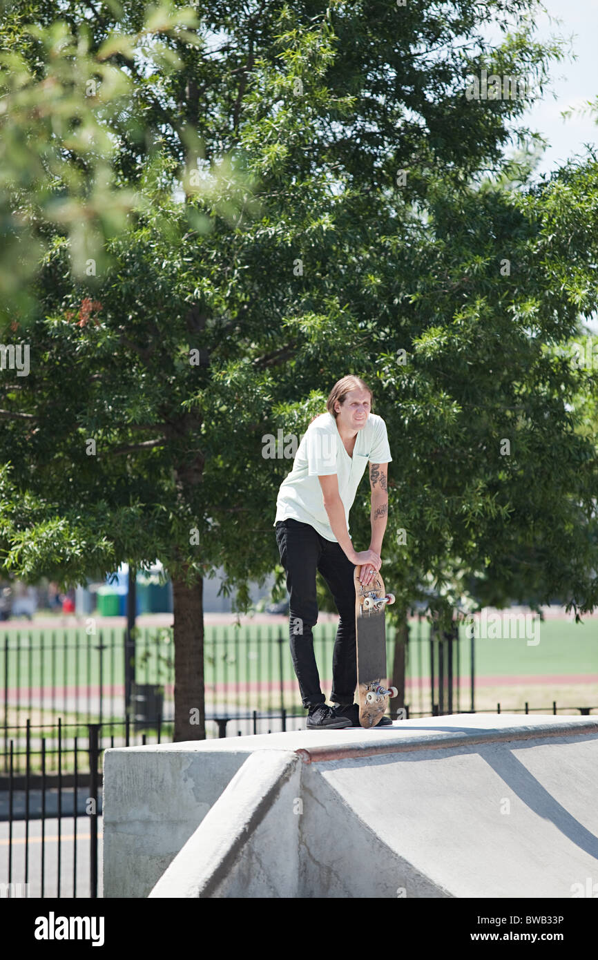 Skateboarder on ramp at skate park Stock Photo - Alamy