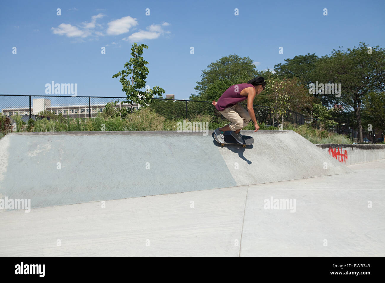Skateboarder on ramp at skate park Stock Photo - Alamy