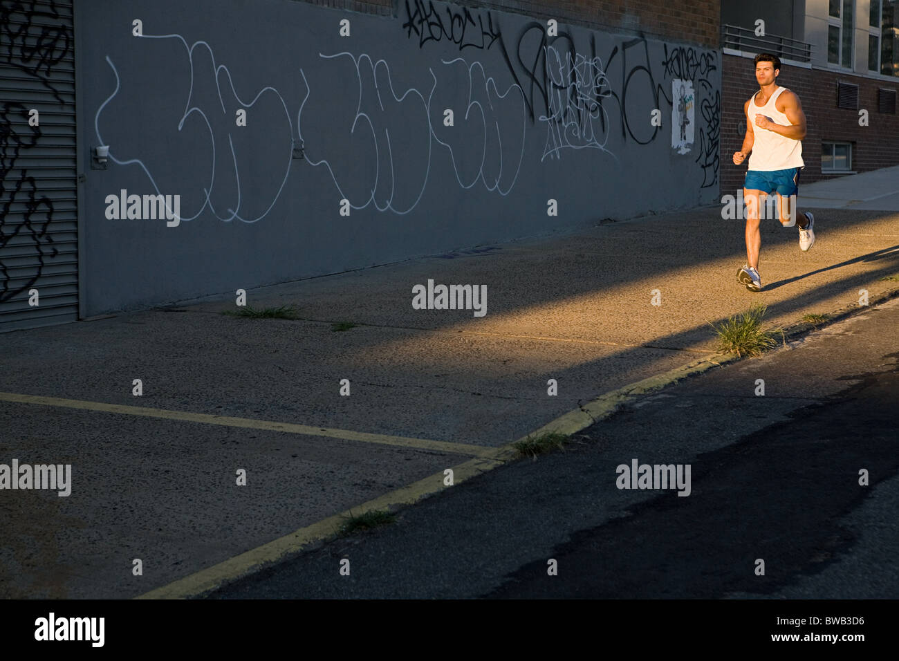 Male runner on urban street Stock Photo - Alamy