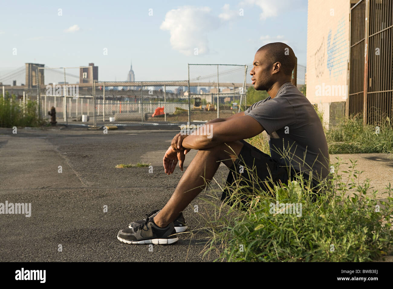 Runner sitting on street in brooklyn Stock Photo - Alamy