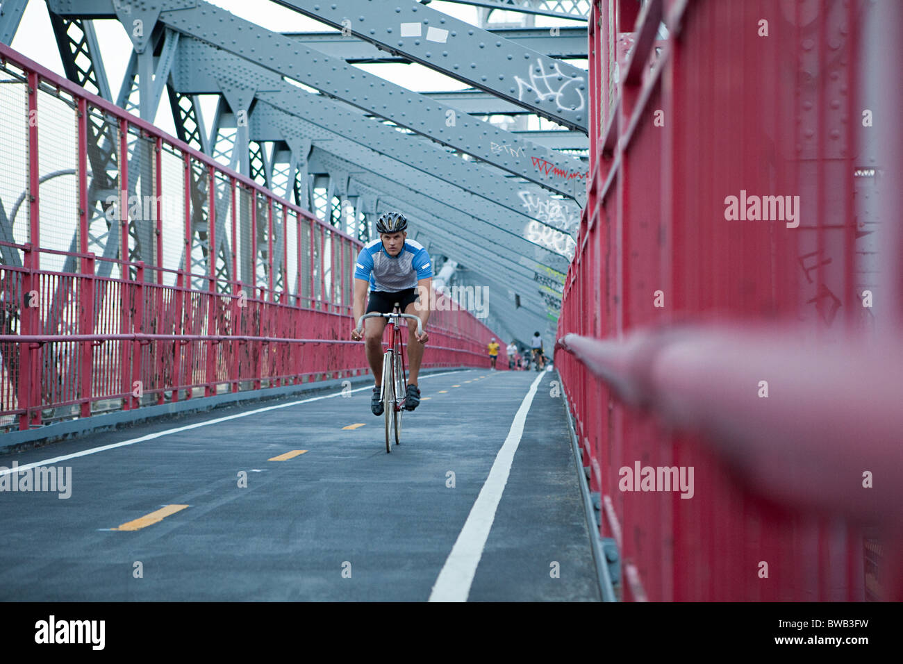 Man cycling over bridge Stock Photo - Alamy