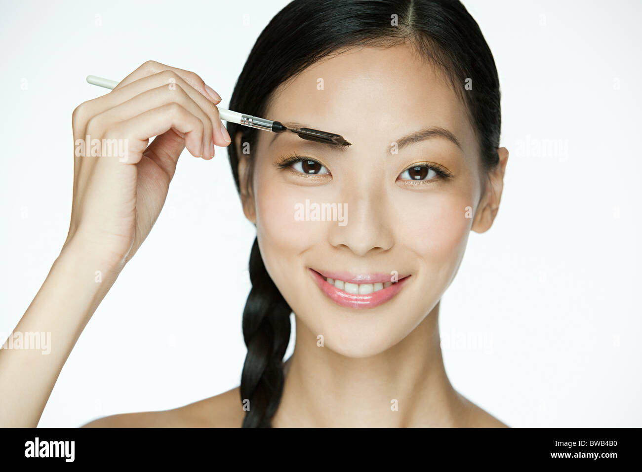 Young woman using eyebrow comb Stock Photo - Alamy