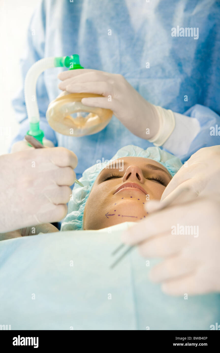 Photo of young female patient with closed eyes before operation with ...