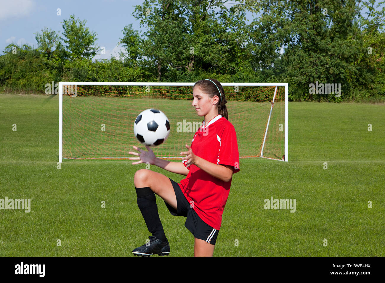 Girl soccer player with ball Stock Photo - Alamy