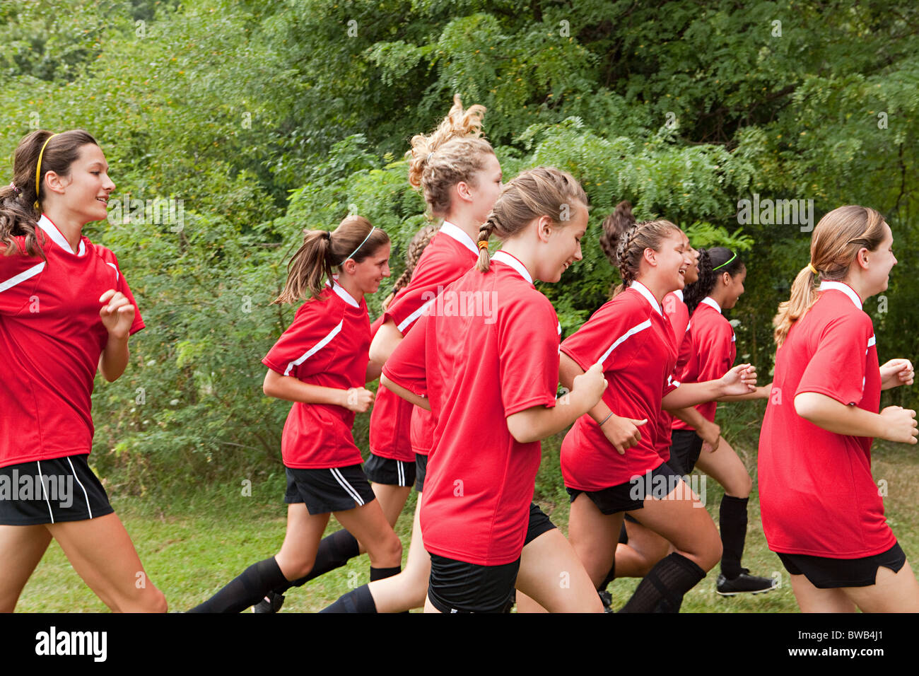 Girl soccer players running Stock Photo - Alamy