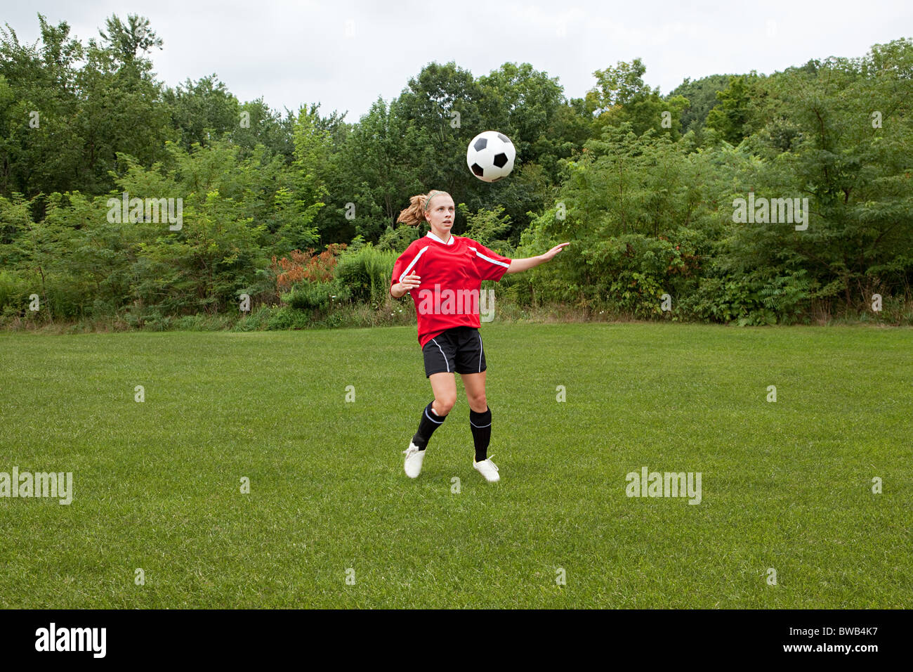 Girl soccer player with ball Stock Photo - Alamy