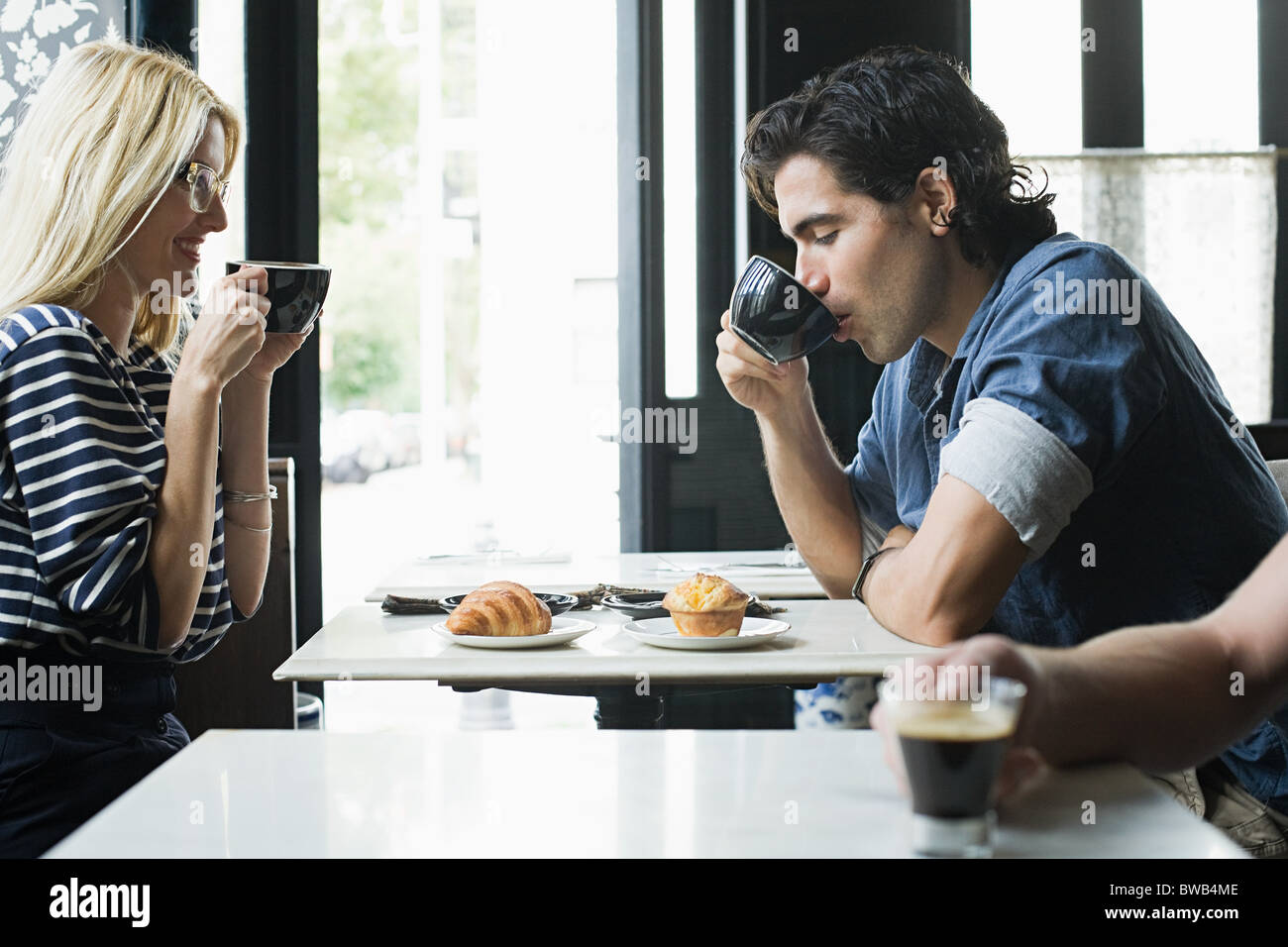 Couple having coffee in cafe Stock Photo - Alamy