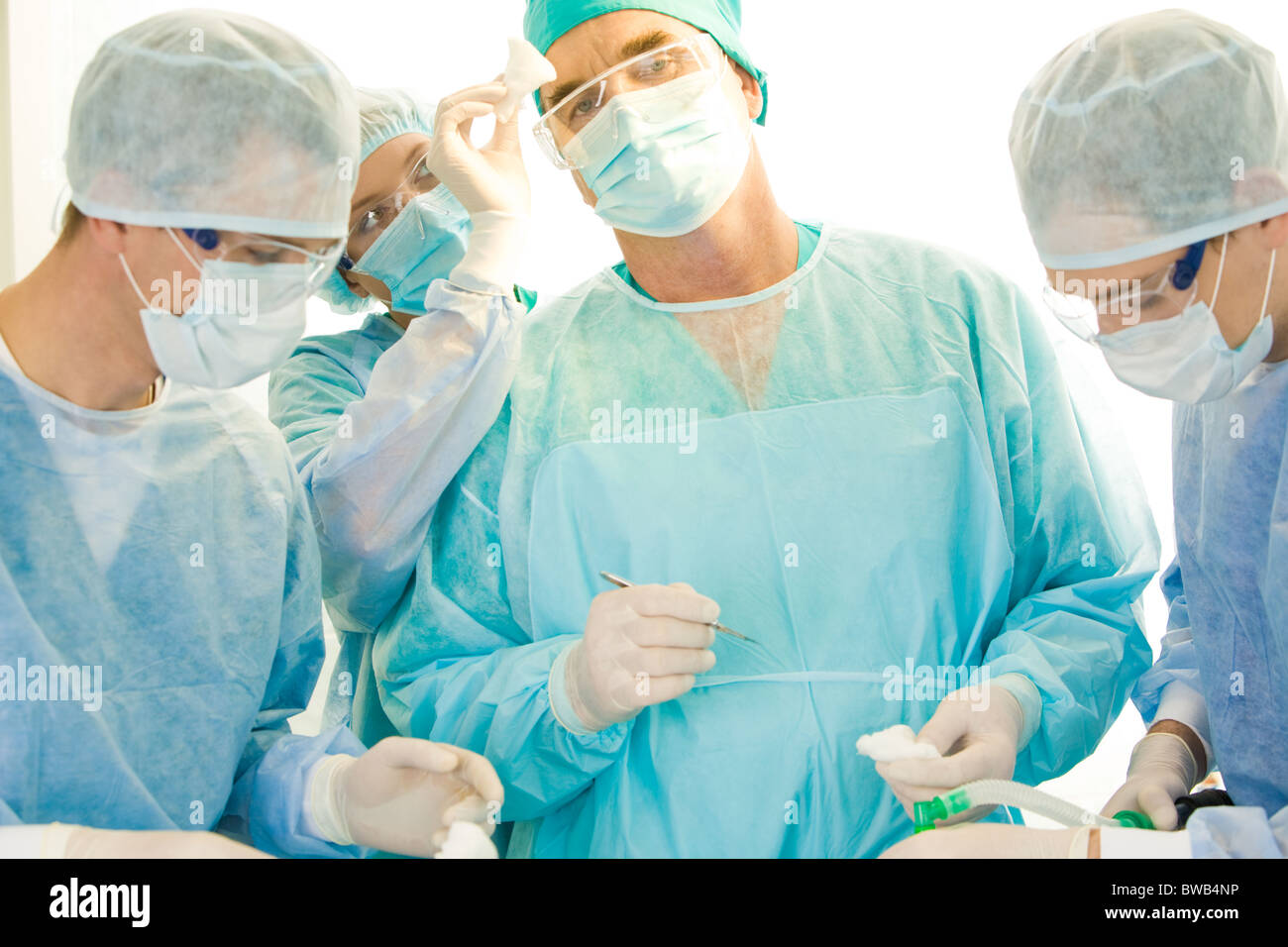 Group of surgeons making operation on patient’s belly in clinic Stock ...